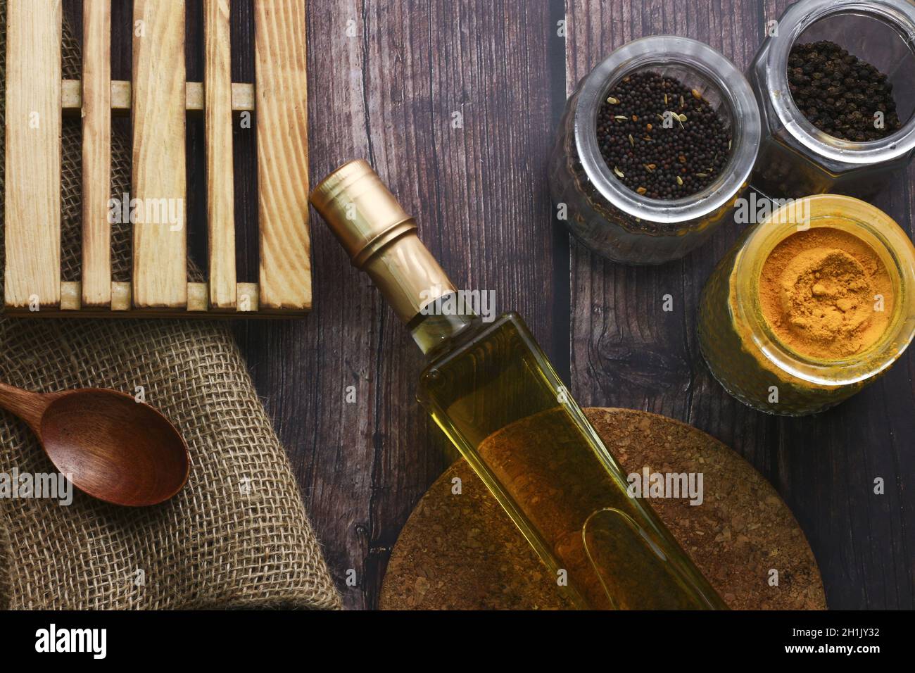 Flat lay of a kitchen table with oil bottle and spices for copy space ...