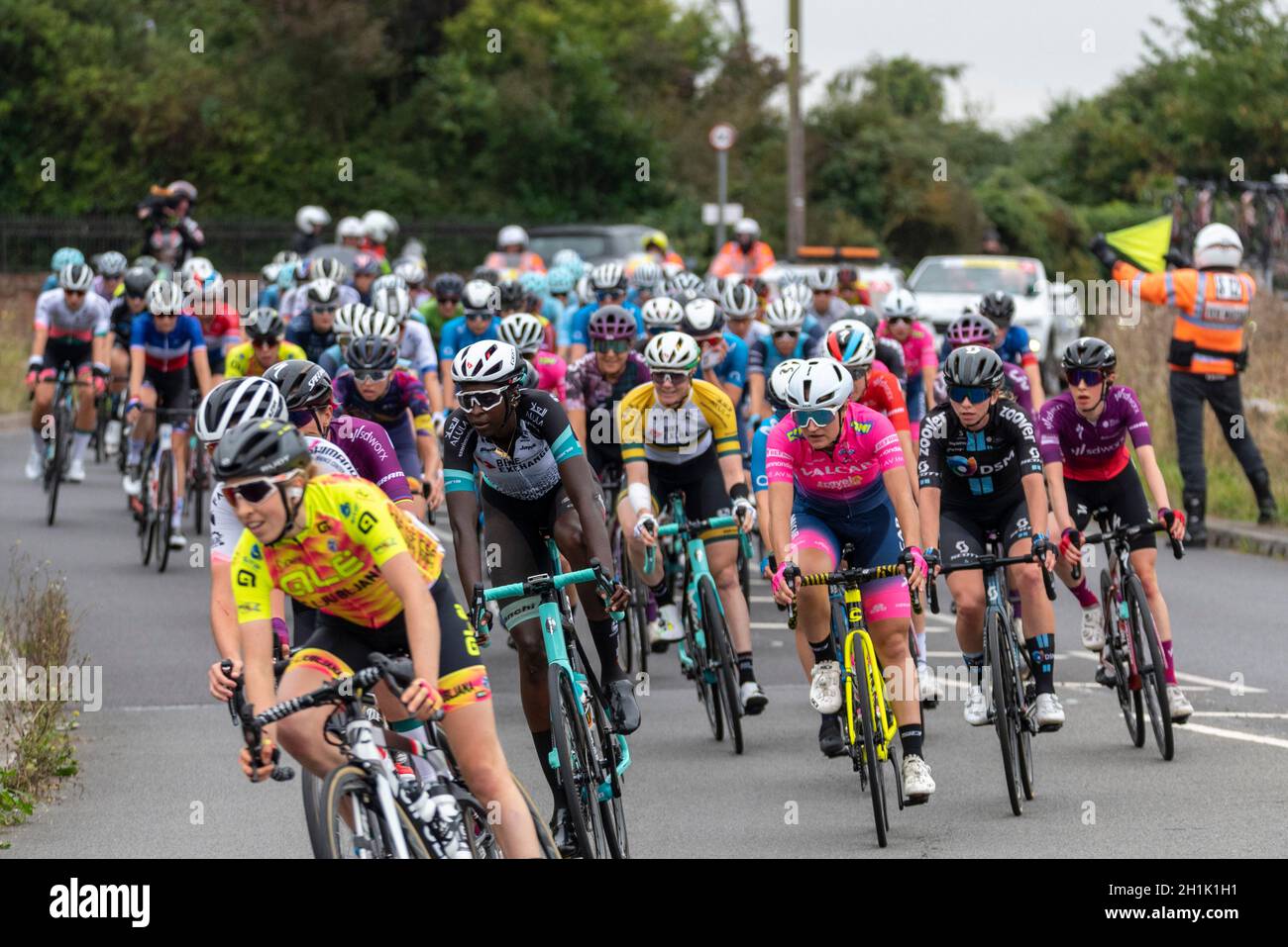 The peloton group of female cyclists round the Rettendon Turnpike ...