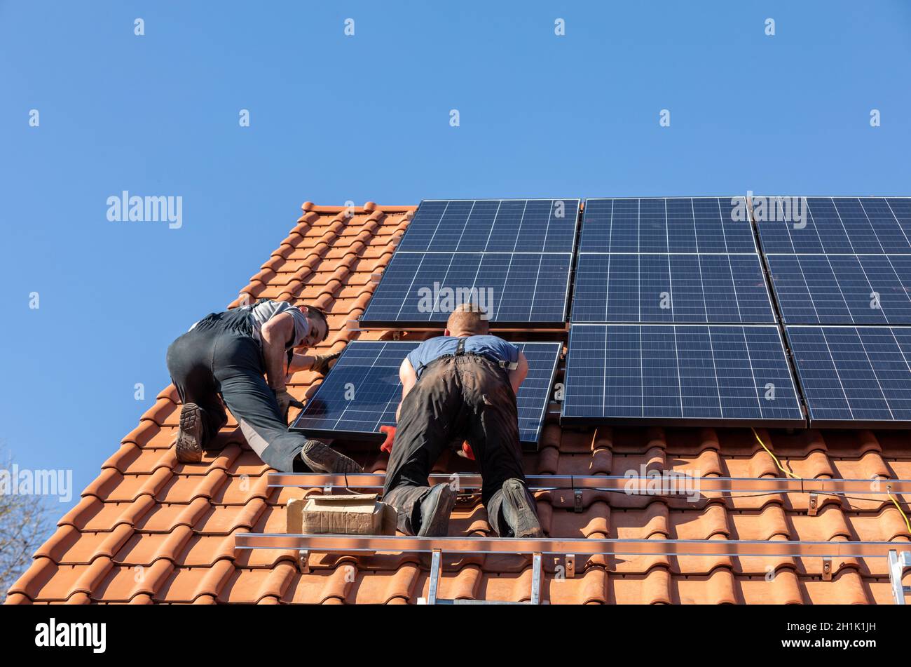 Ochojno, Poland - April 8, 2020: Workers installing solar electric ...