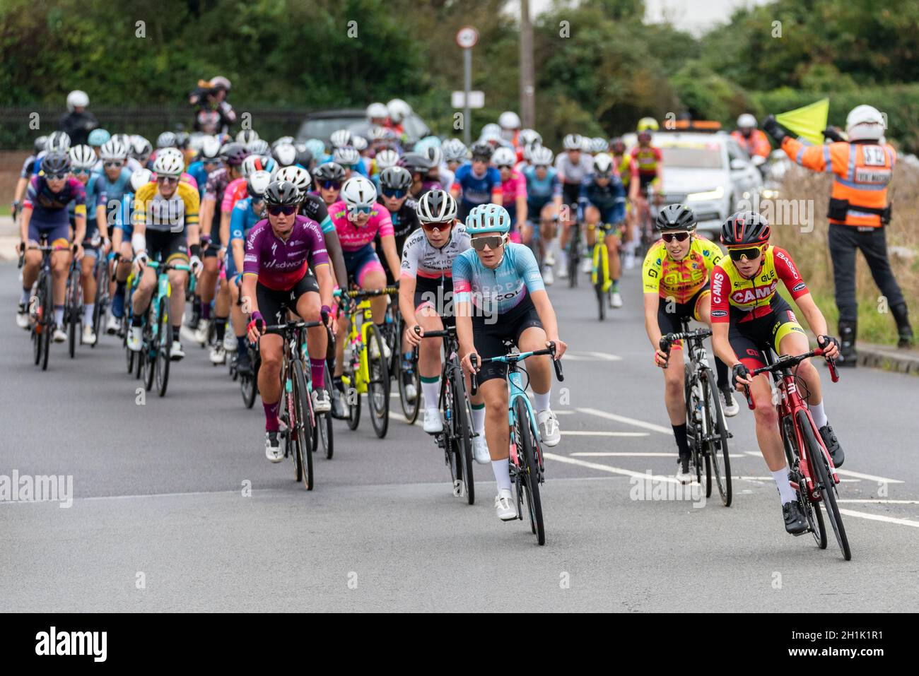 The peloton group of female cyclists round the Rettendon Turnpike ...