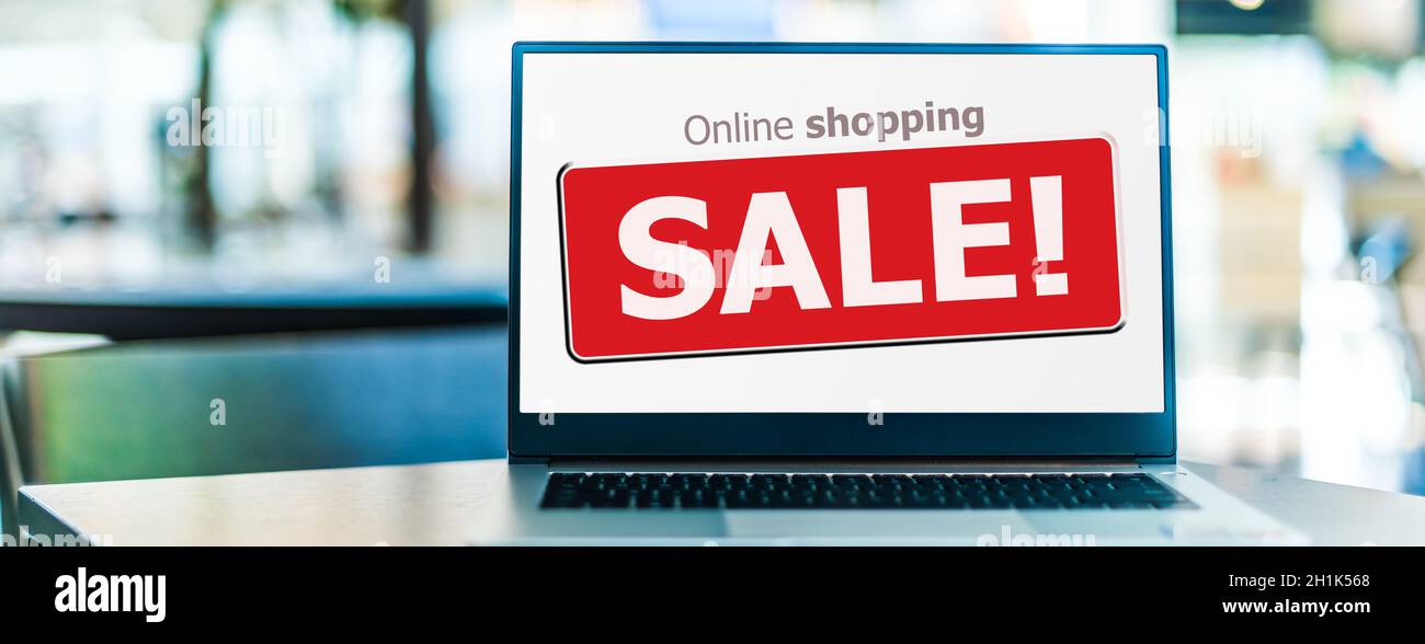 Laptop computer displaying a commercial sale sign on internet shopping ...