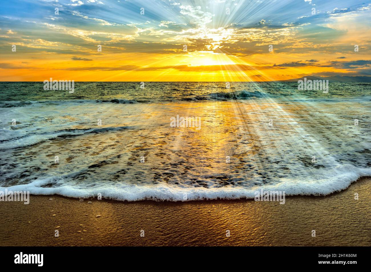 Sun Rays Emanate From The Ocean Sunset Sky As A Gentle Wave Rolls to ...