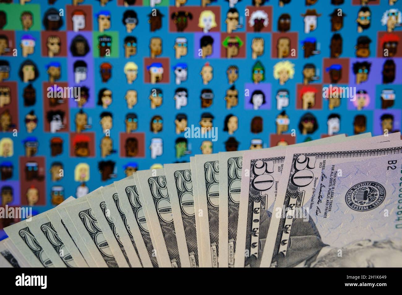 US dollars and part of 10000 CryptoPunks NFT collection on blurred ...