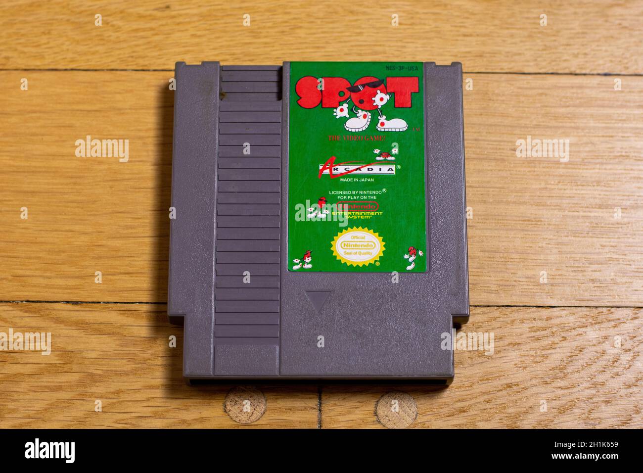 A Spot Cartridge for the Nintendo Entertainment System on a wood floor ...