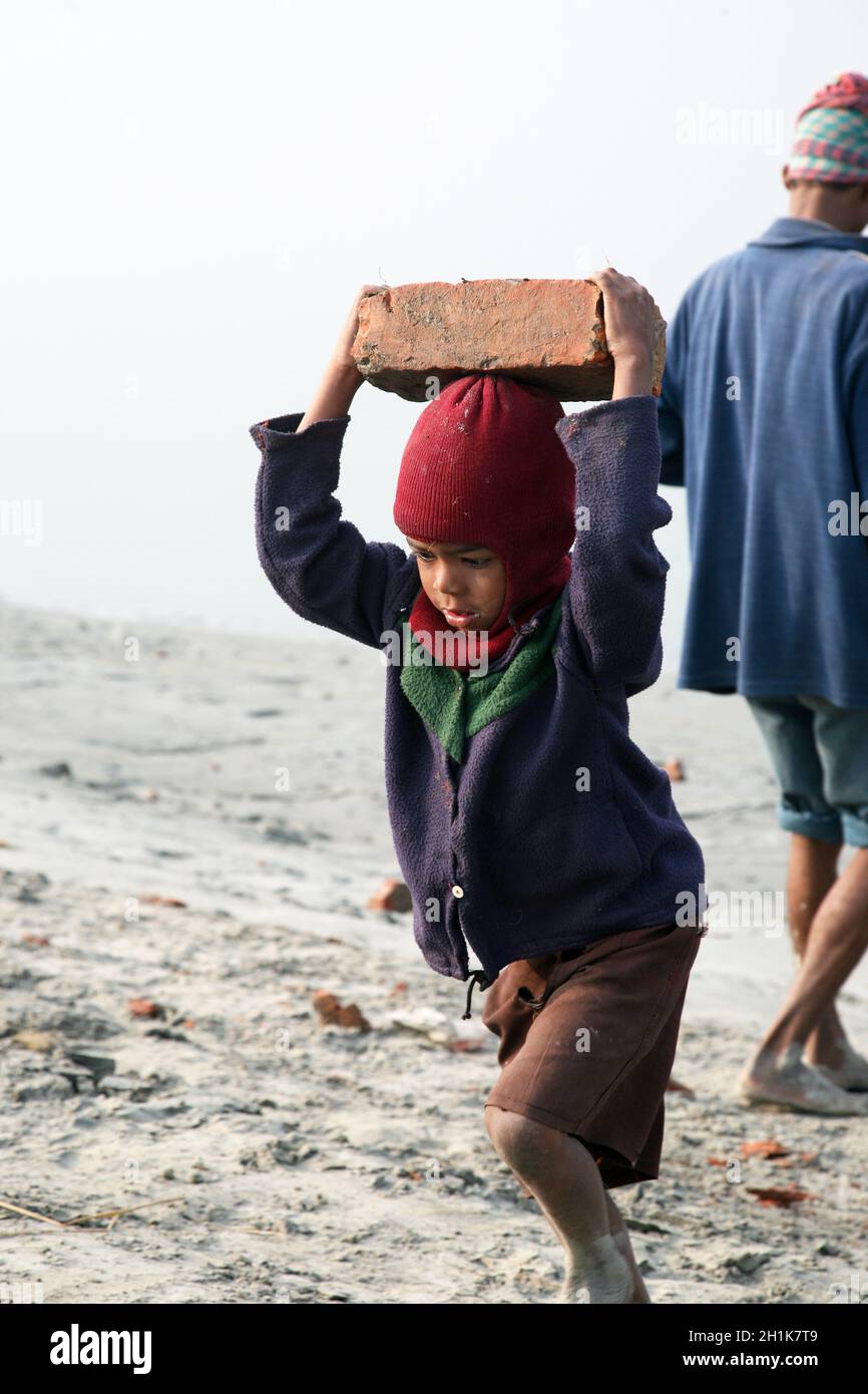 Child workers carry bricks carrying it on his head in Sonakhali, West ...