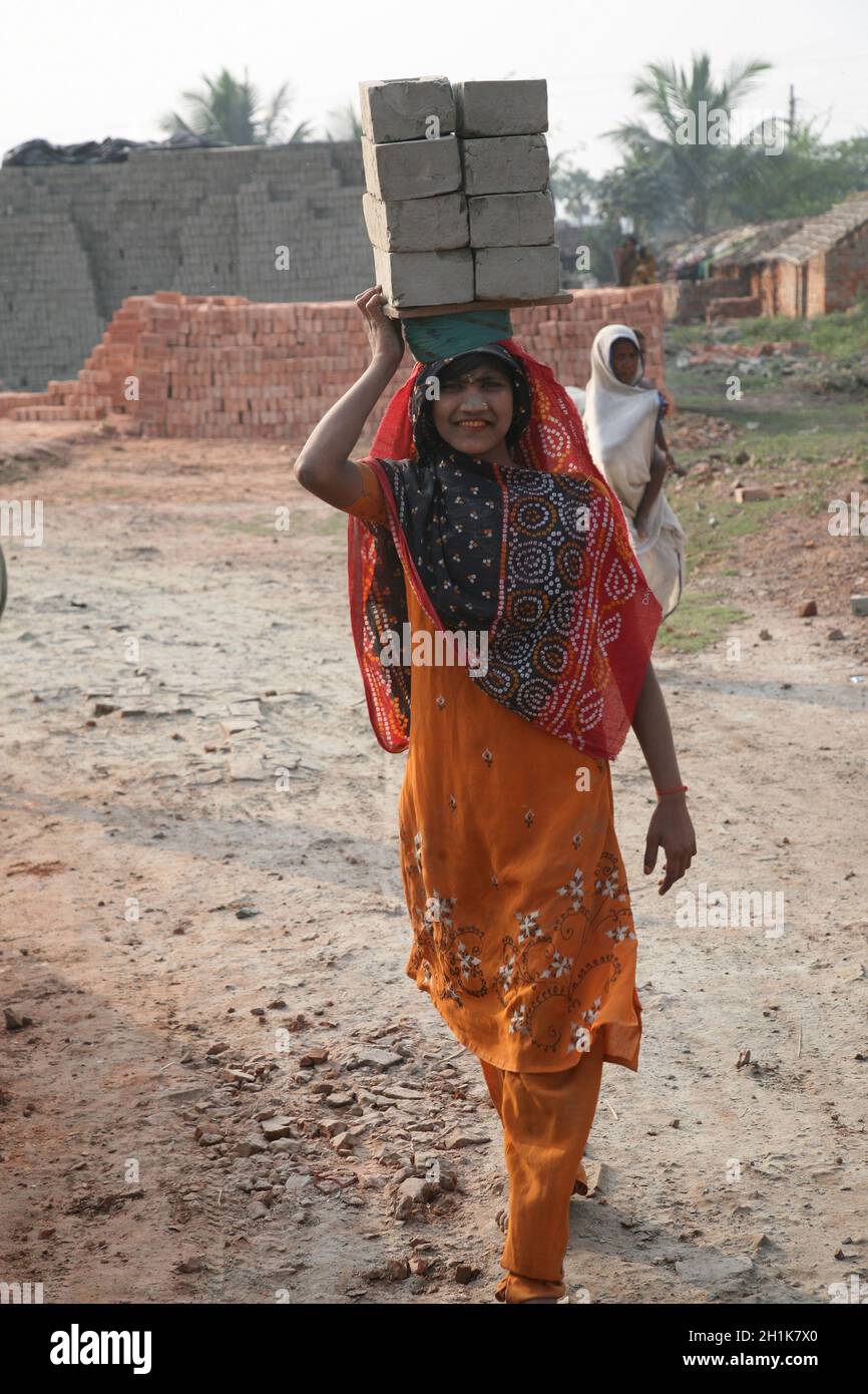 Brick field workers carrying complete finish brick from the kiln in ...