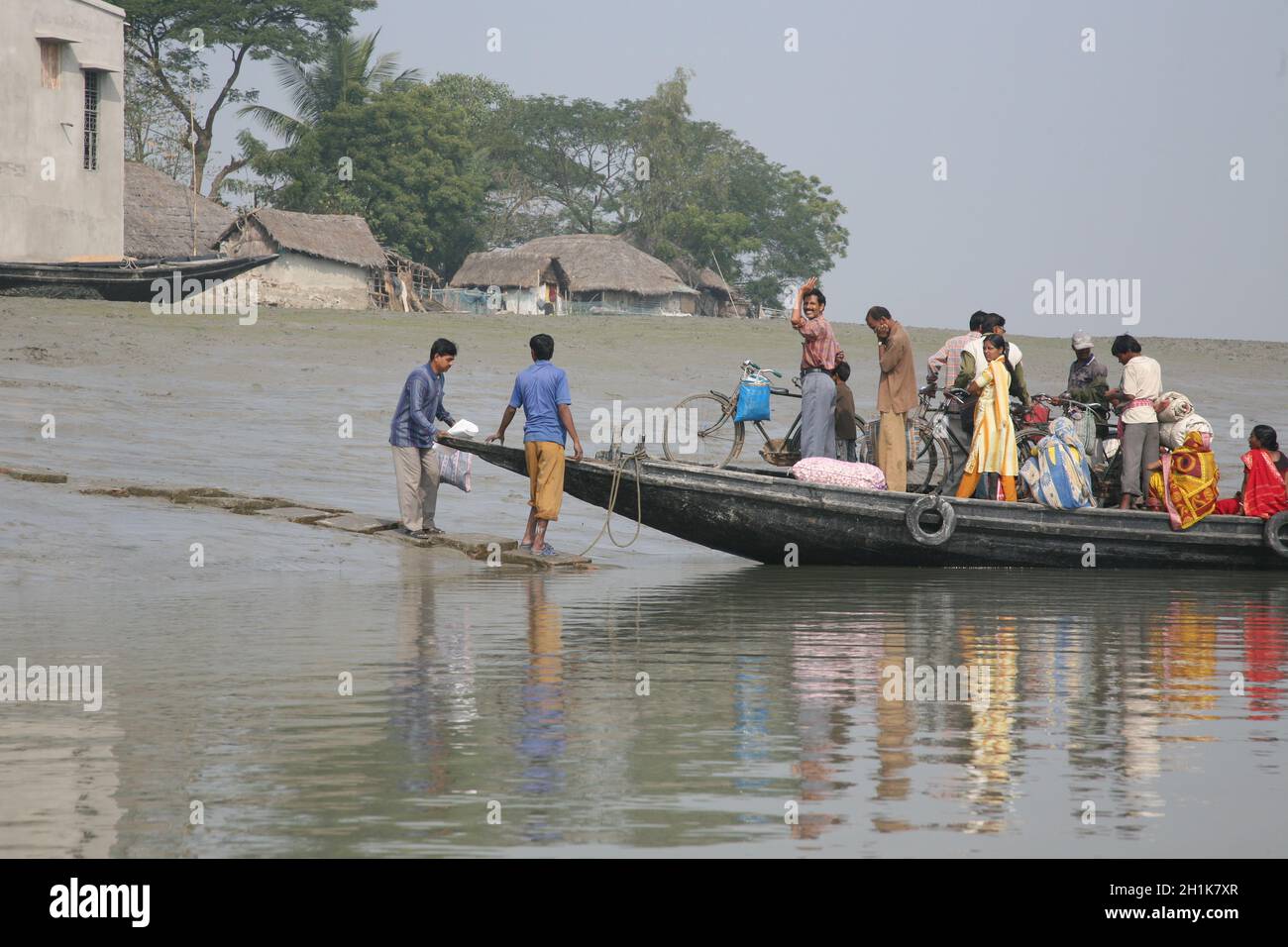 Wooden boat crosses river in Gosaba, West Bengal, India Stock Photo - Alamy