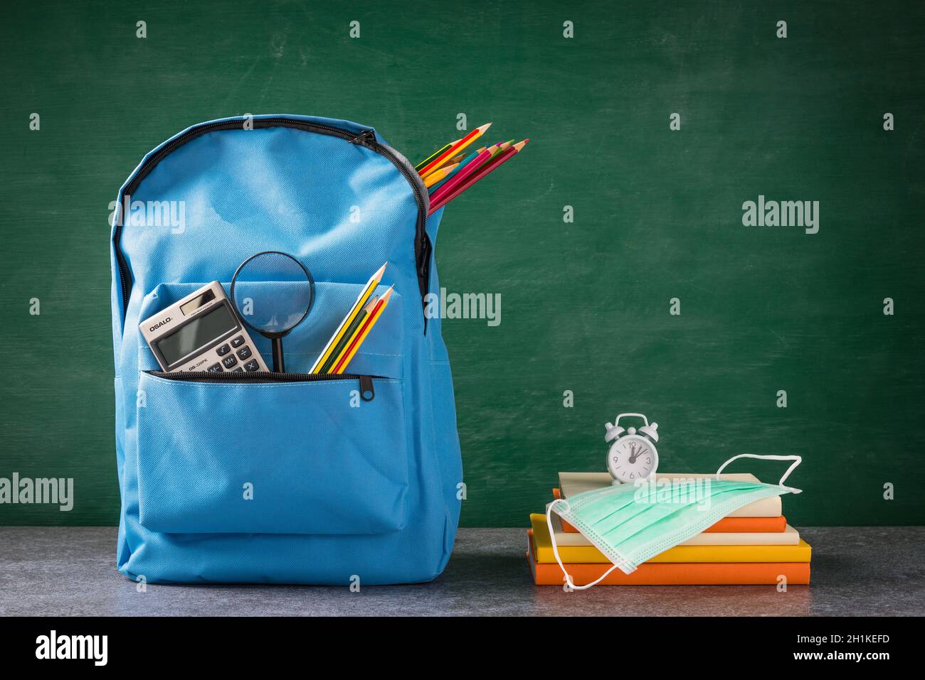 Front school backpack and accessories with face mask protect on table ...