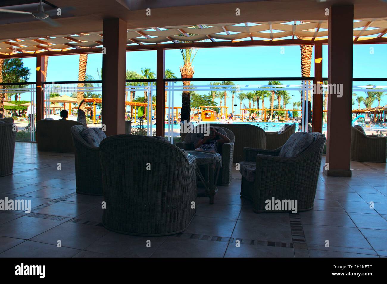 People have a rest in cafe of resort hotel. Beautiful panorama seen ...