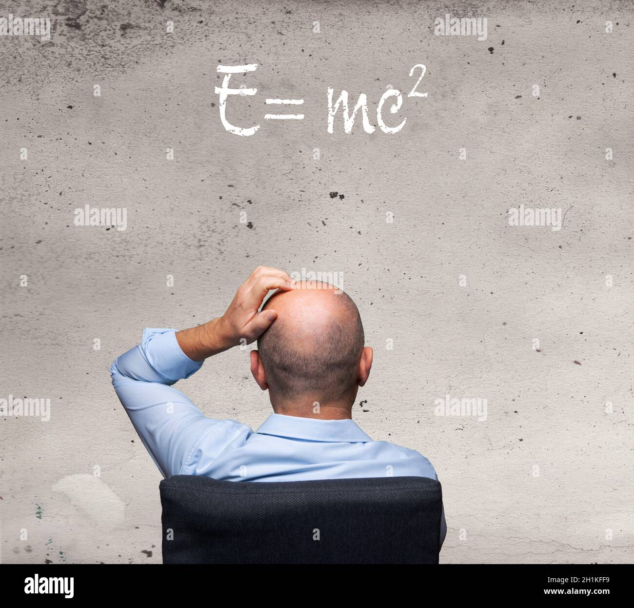 a man reading the relativity formula written on a wall Stock Photo - Alamy