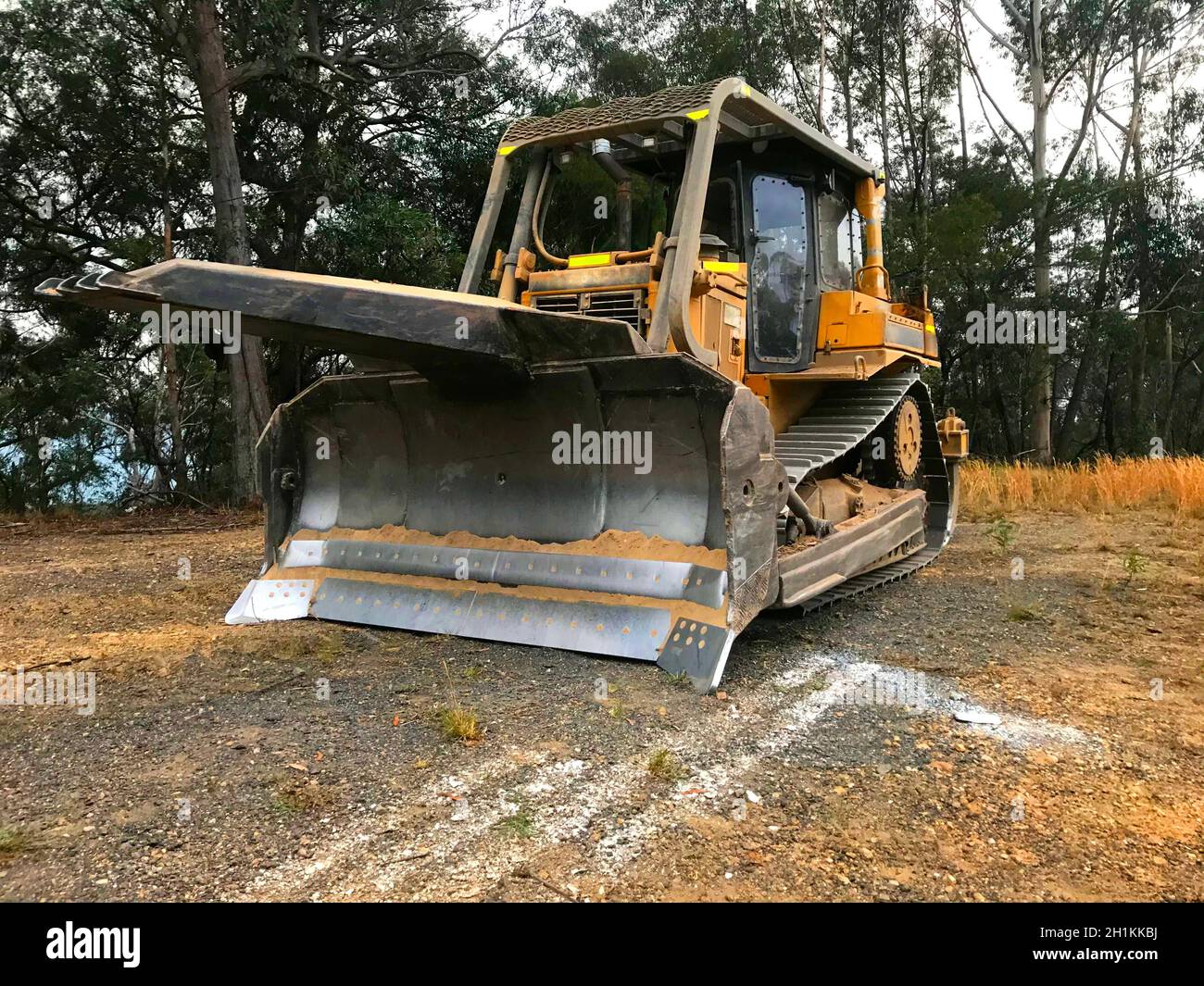 Bulldozer with tree pusher attachment Stock Photo - Alamy