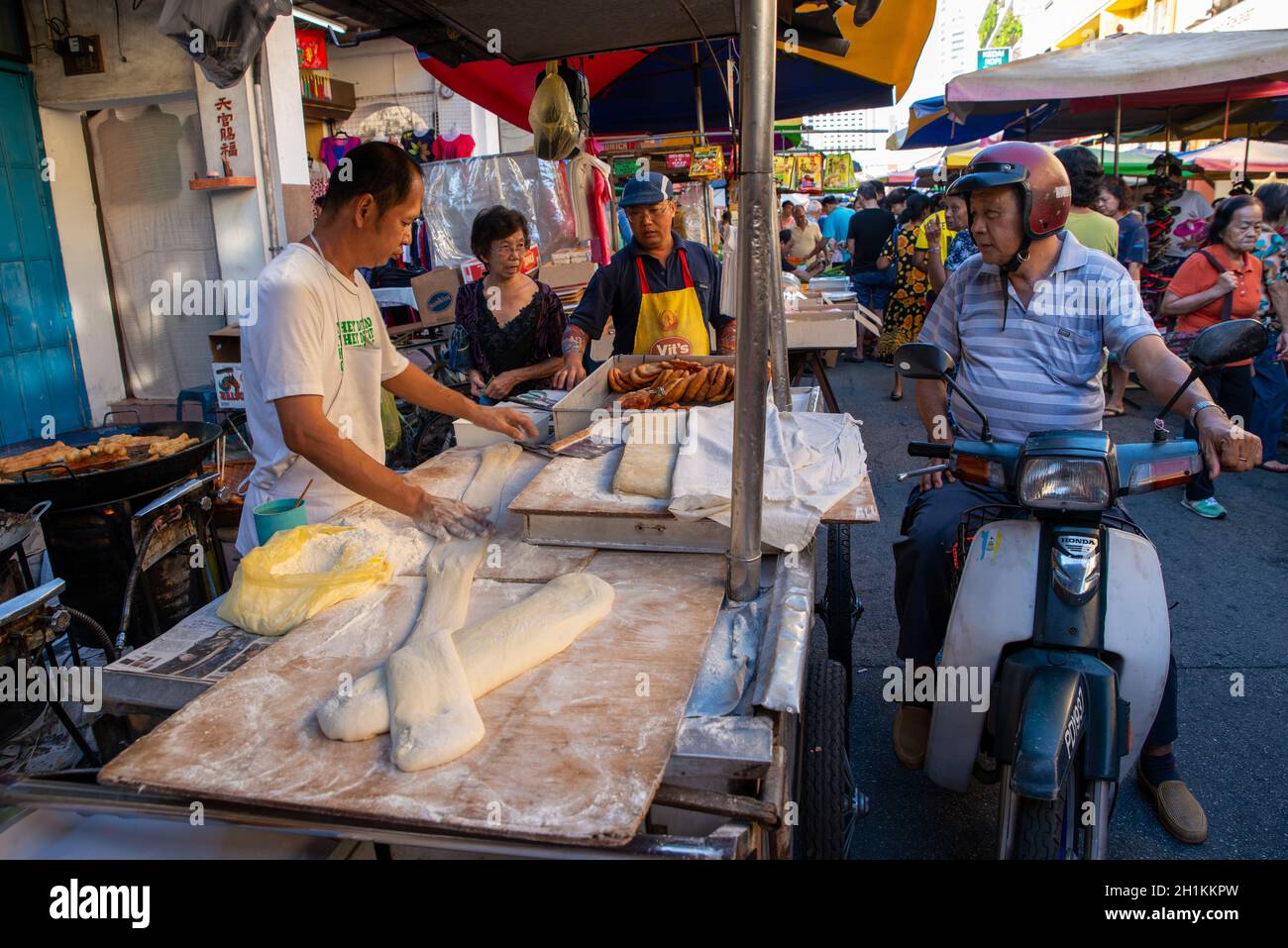 Georgetown, Penang/Malaysia - Jul 30 2016: A man ride motor to buy deep ...