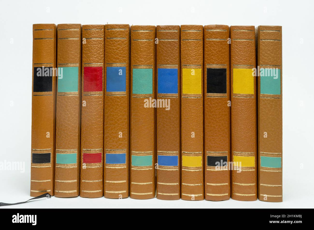 Row of color coded brown books isolated on a white background Stock ...