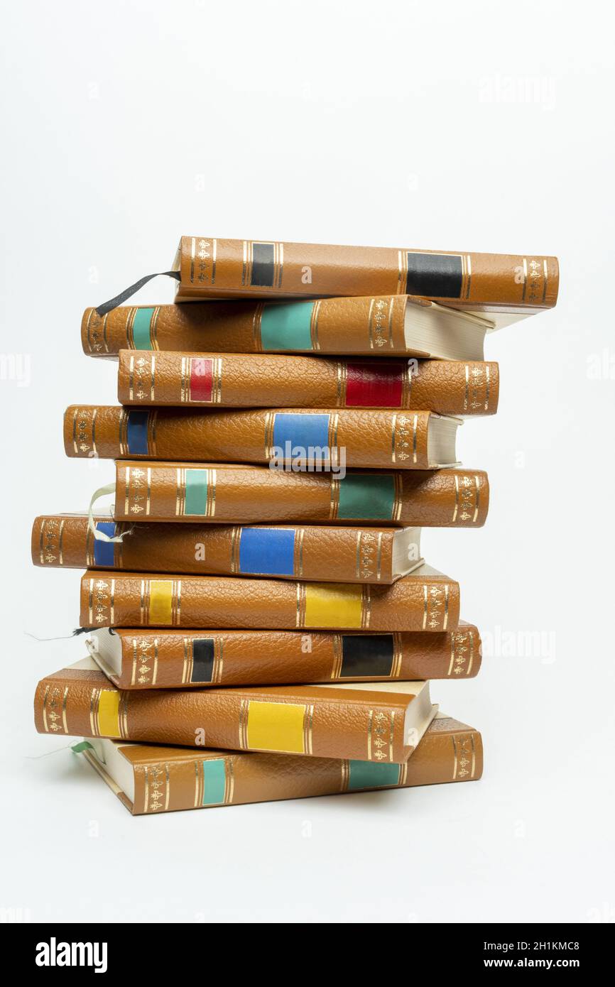 Stack of color coded brown books isolated on a white background Stock ...