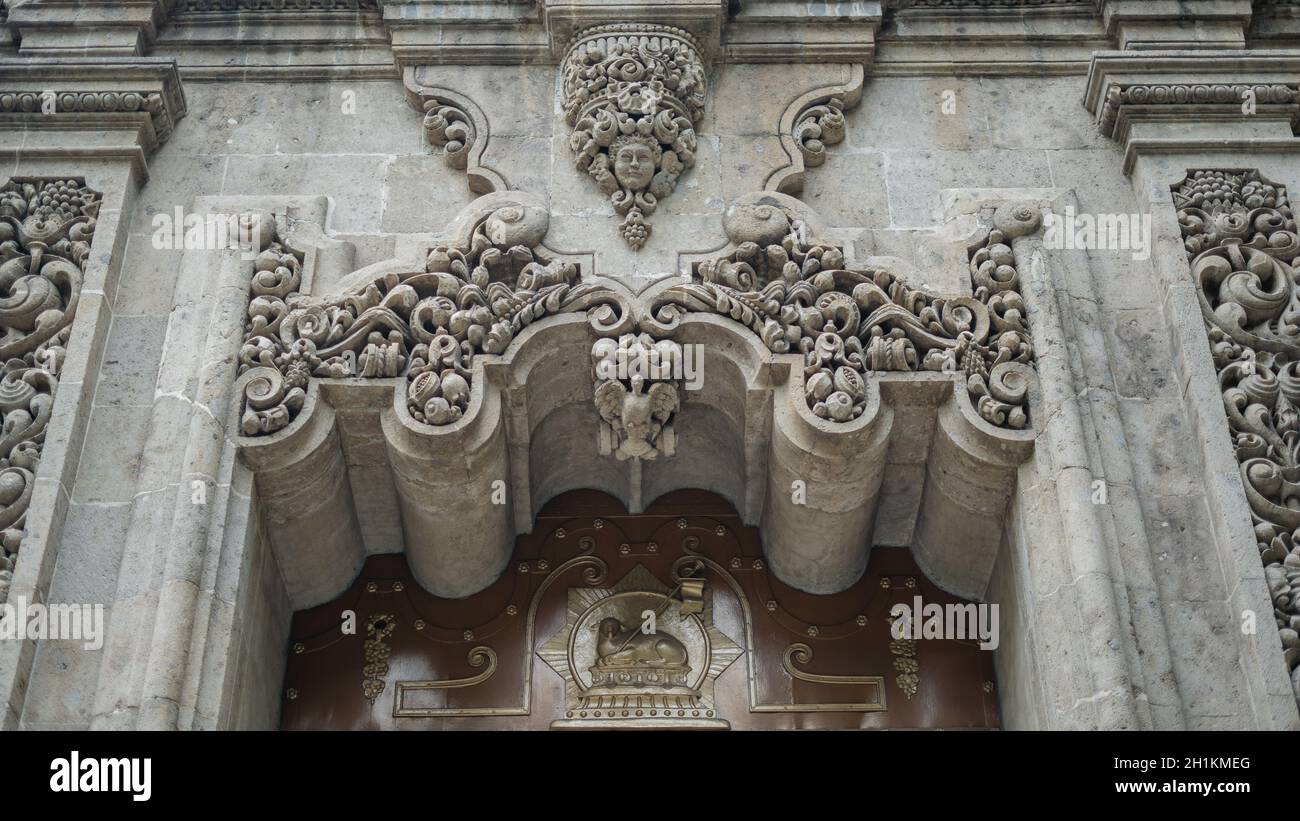 Picture of a sculpted arch over the entrance of a building with ...