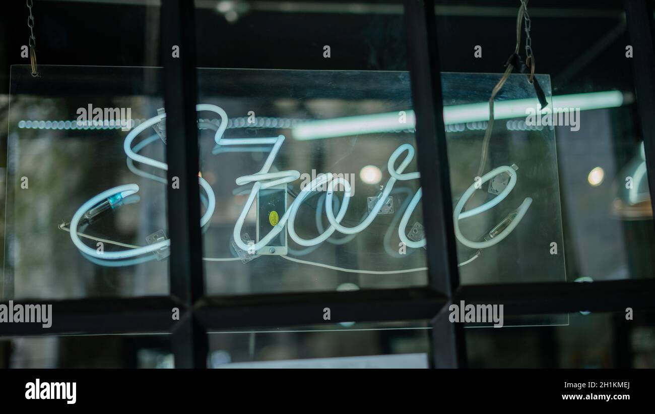 Picture of a blue Store light sign on a window from barber shop and ...