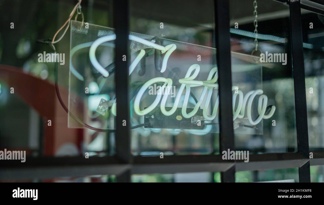 Picture of a blue Tattoo light sign on a window from a tattoo studio ...