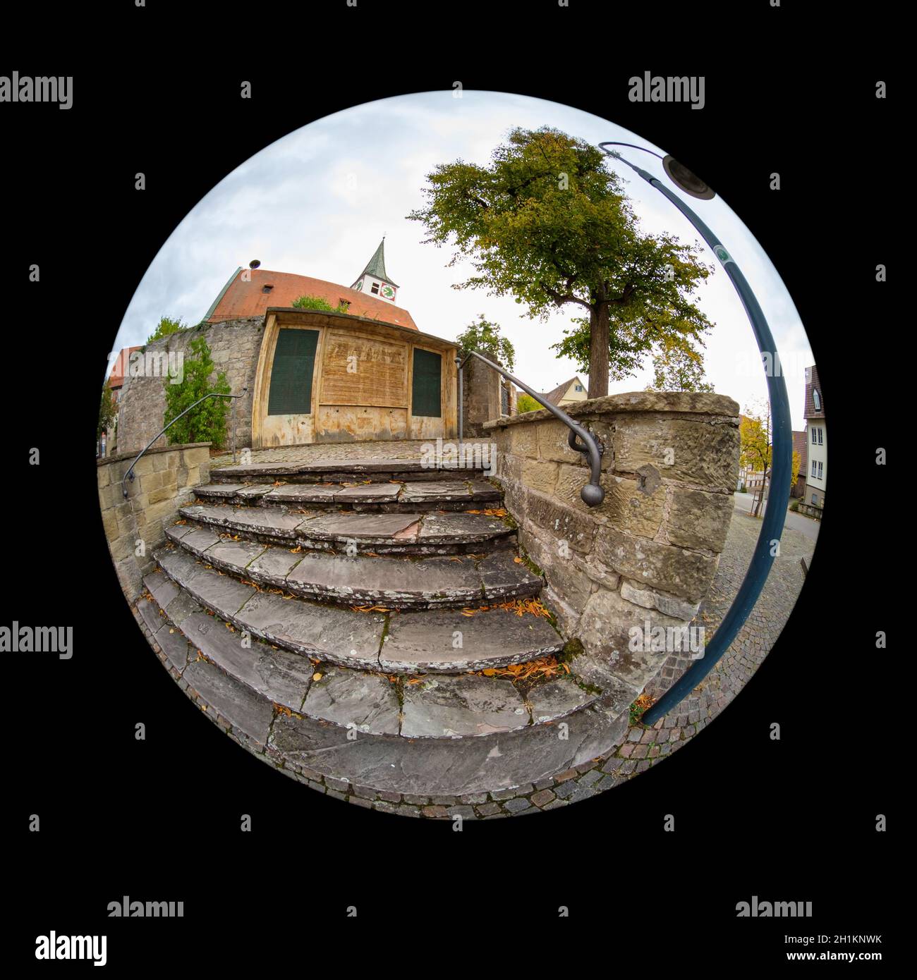 Old stairs of stone in front of a german church with fish eye ...