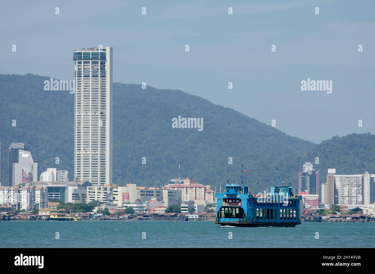 Butterworth, Penang/Malaysia - Jan 01 2020: Blue ferry with KOMTAR ...