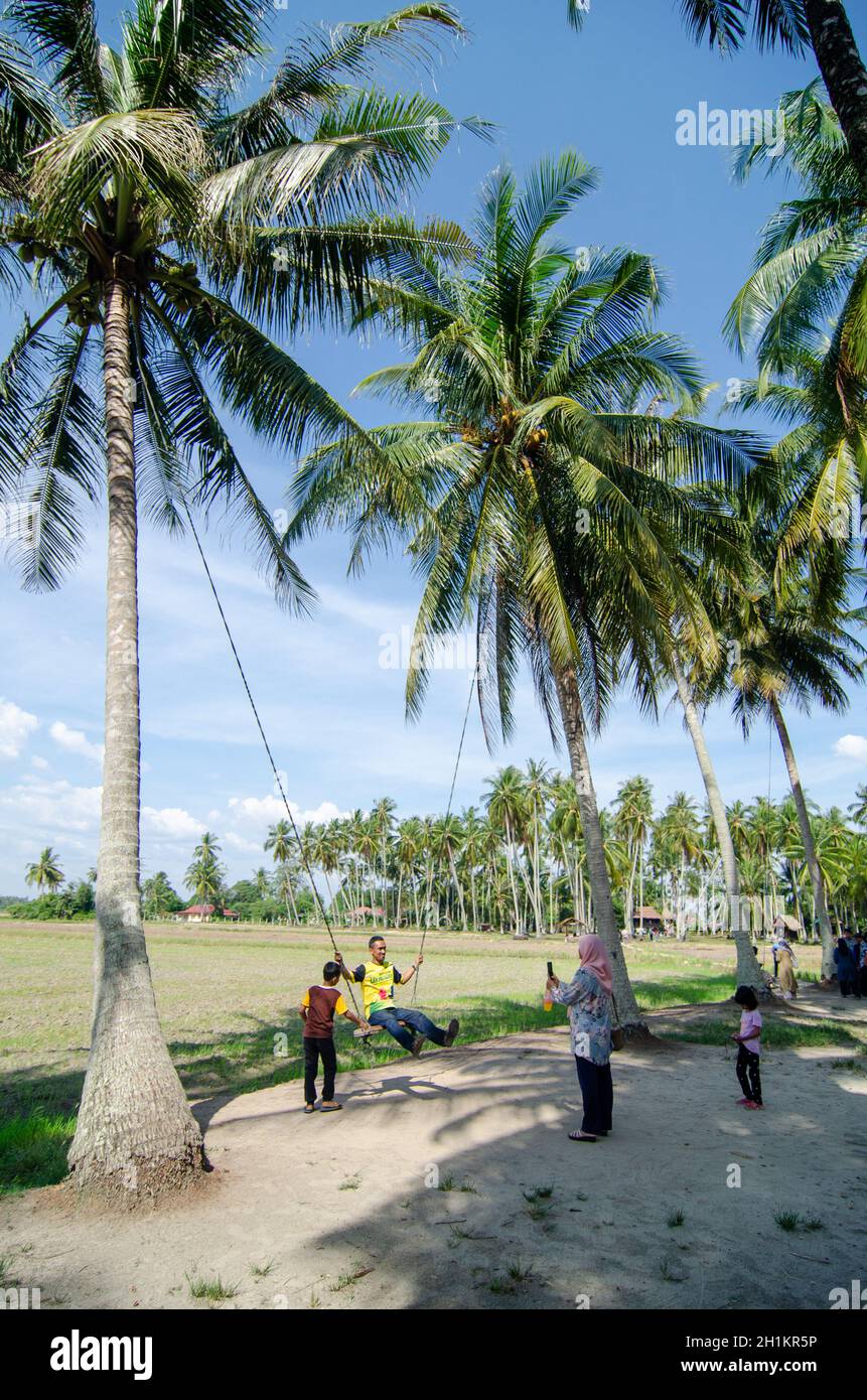 Penaga, Penang/Malaysia - Mar 15 2020: Tourist play swing in Kampung ...