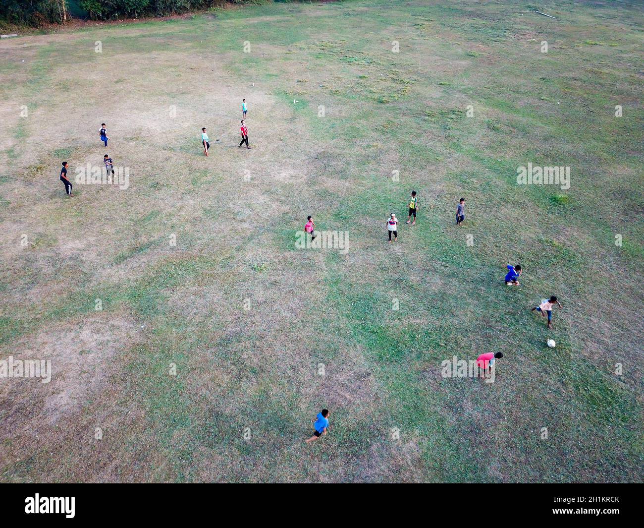 Malays kids have fun cycle, play football in green field Stock Photo ...