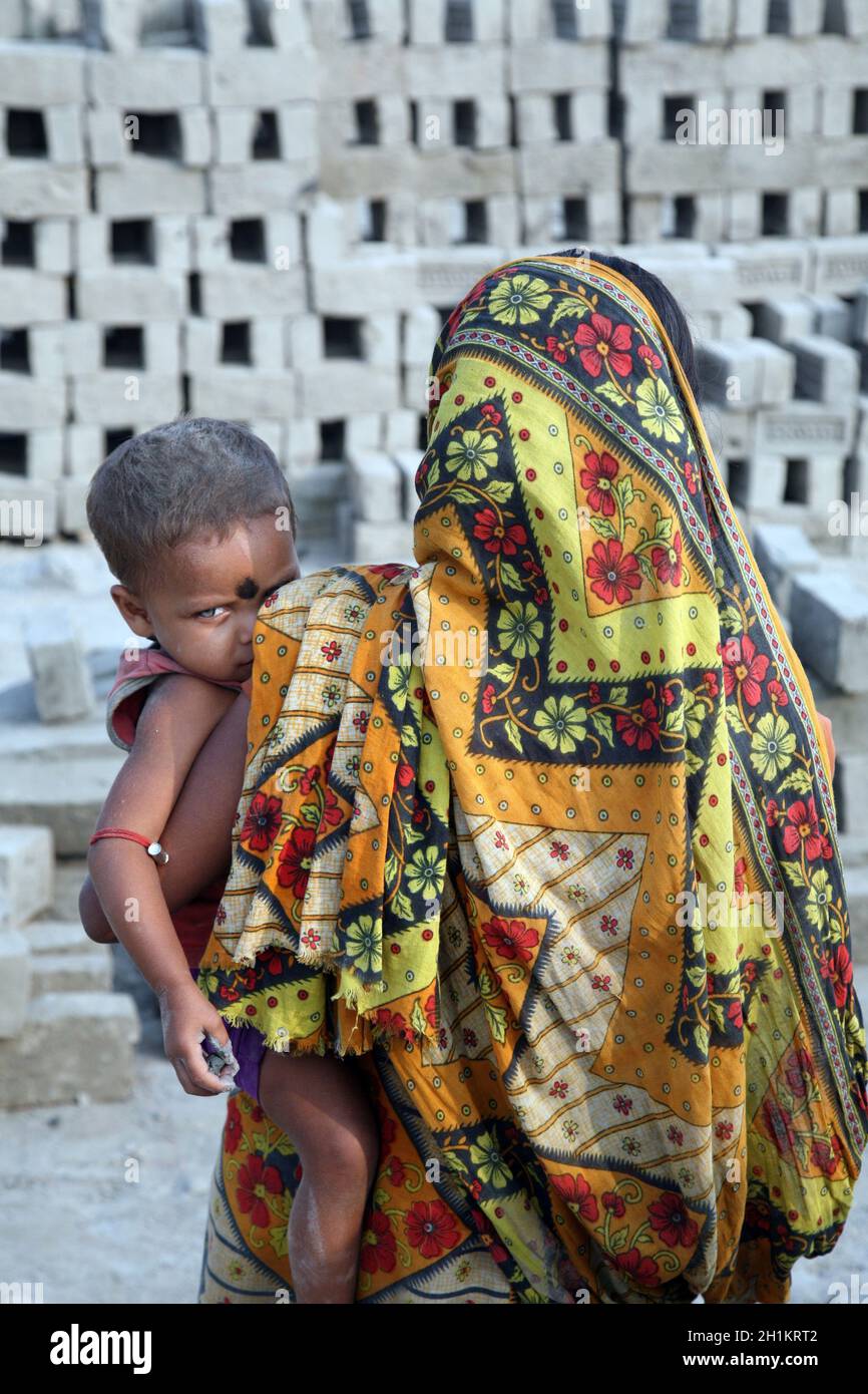 Workers live with their families within the brick factory, where they ...