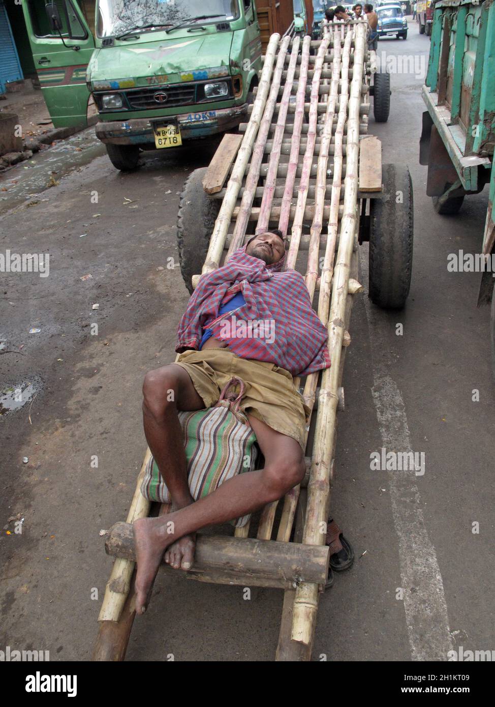 Indian man asleep waiting for customers to transport their cargo in ...