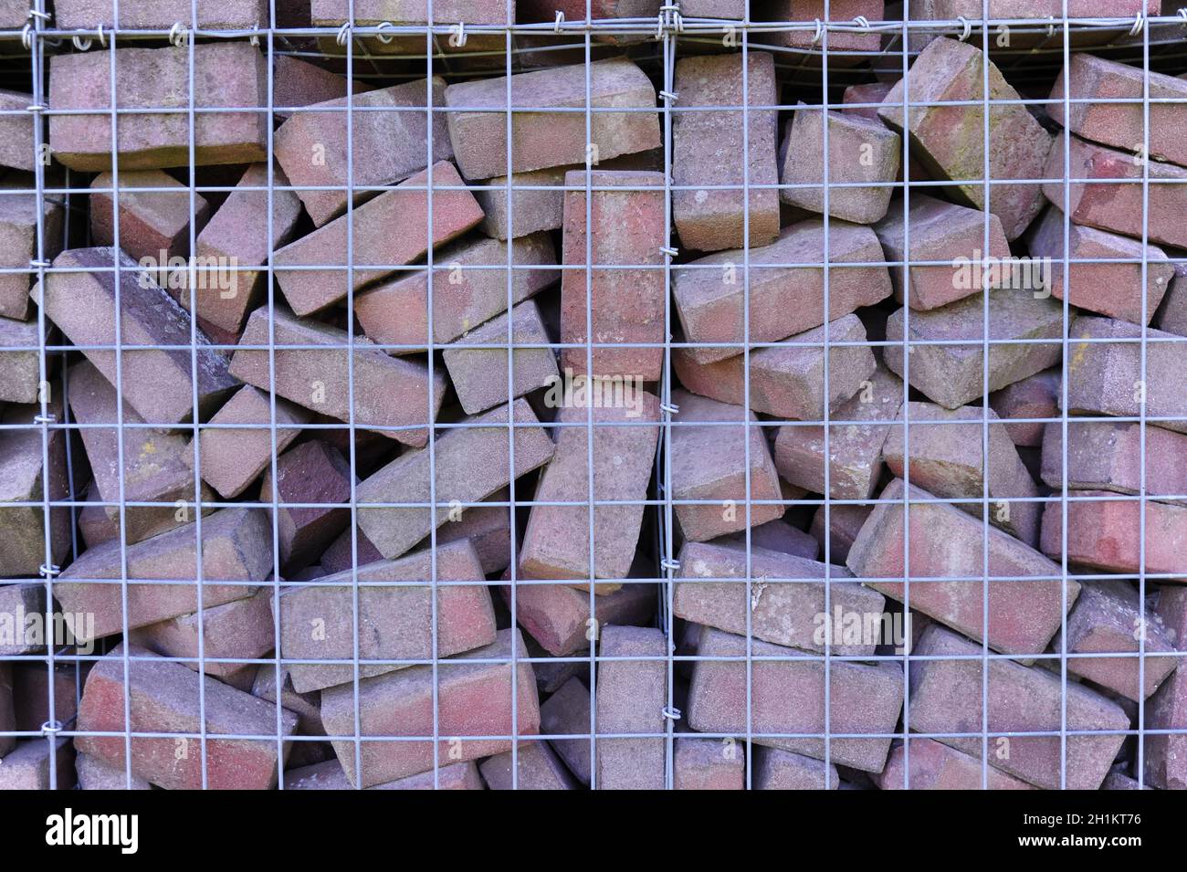 Closeup of a gabion using wire mesh and bricks for engineering construc ...