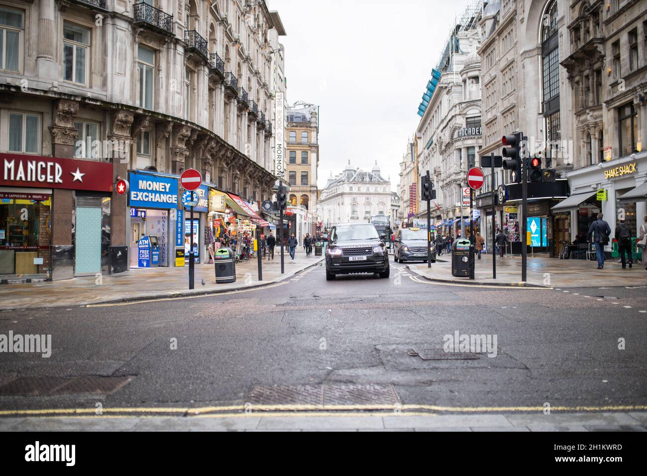 Picture of a black car driving towards the camera in a narrow one-way ...