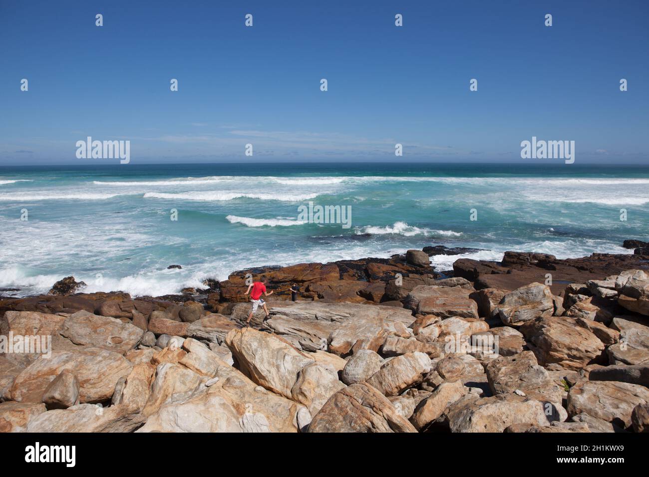 Young tween teen boy exploring the rocky beach Cape of Good Hope Stock ...