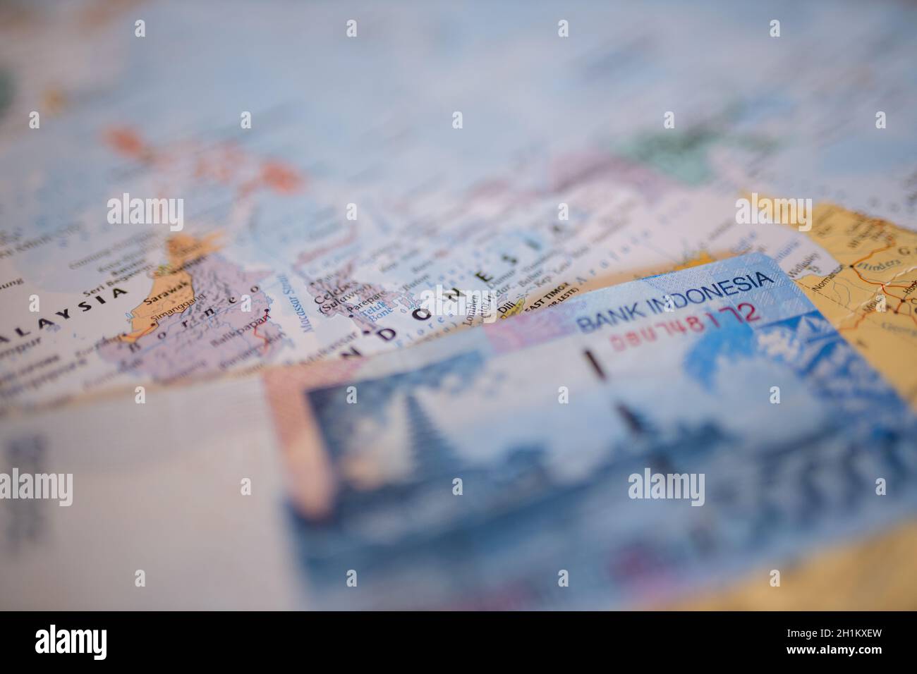 Fifty thousand Indonesian rupiah banknote below Indonesia on a map of ...