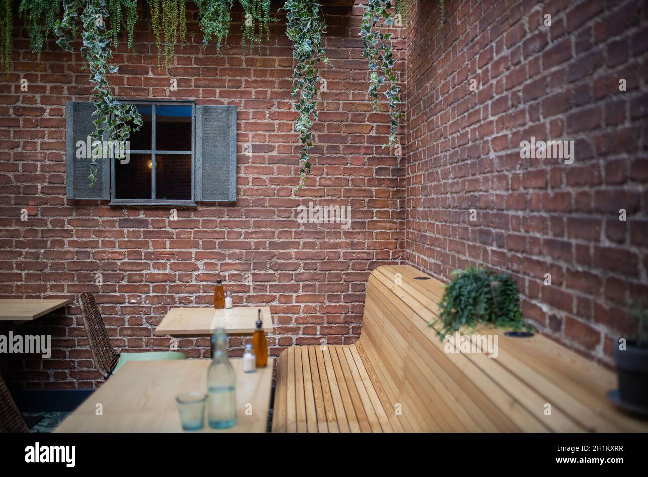 Picture of a red brick corner inside a vegan restaurant, with a window ...