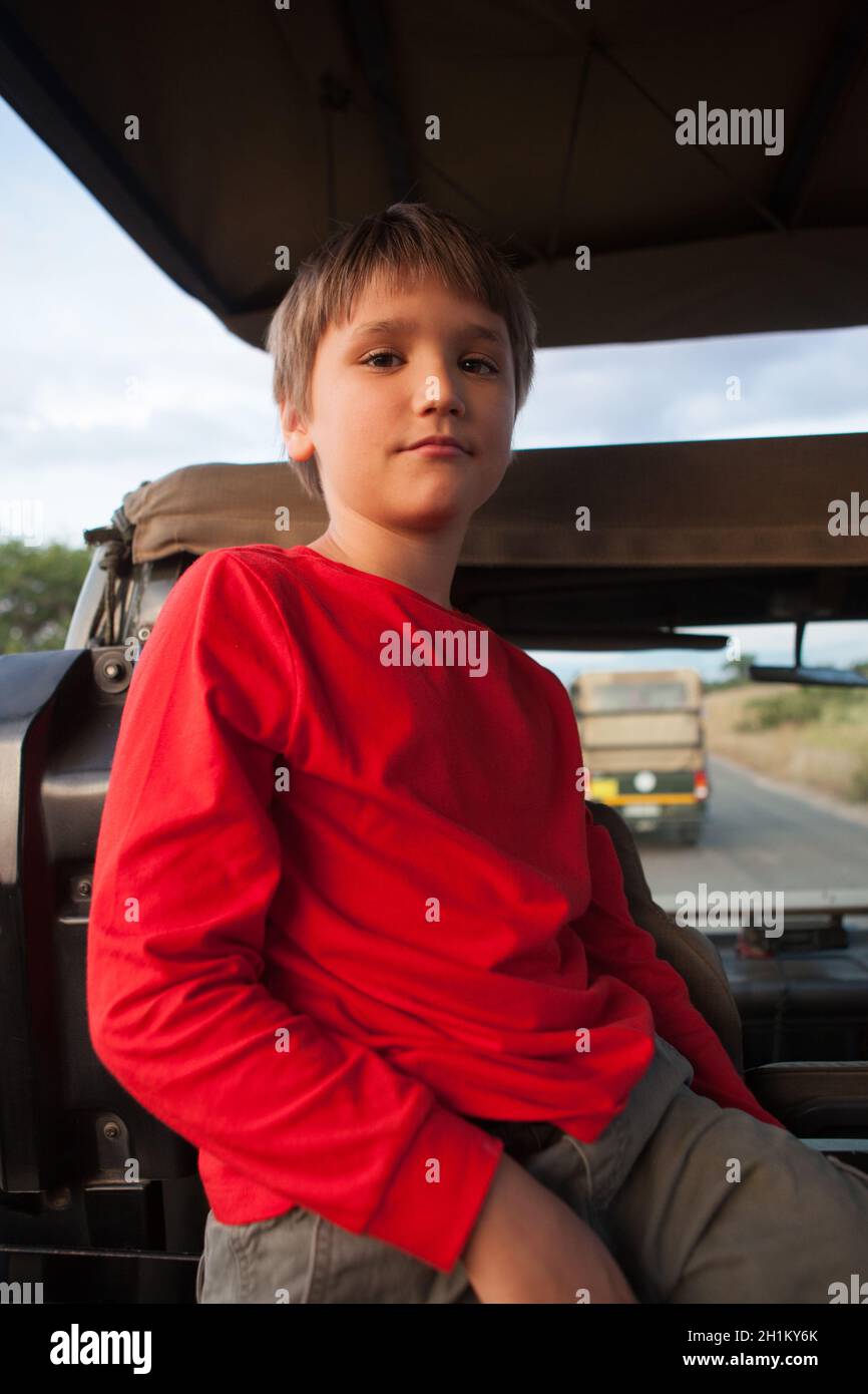 Young tween boy on safari in jeep Stock Photo - Alamy