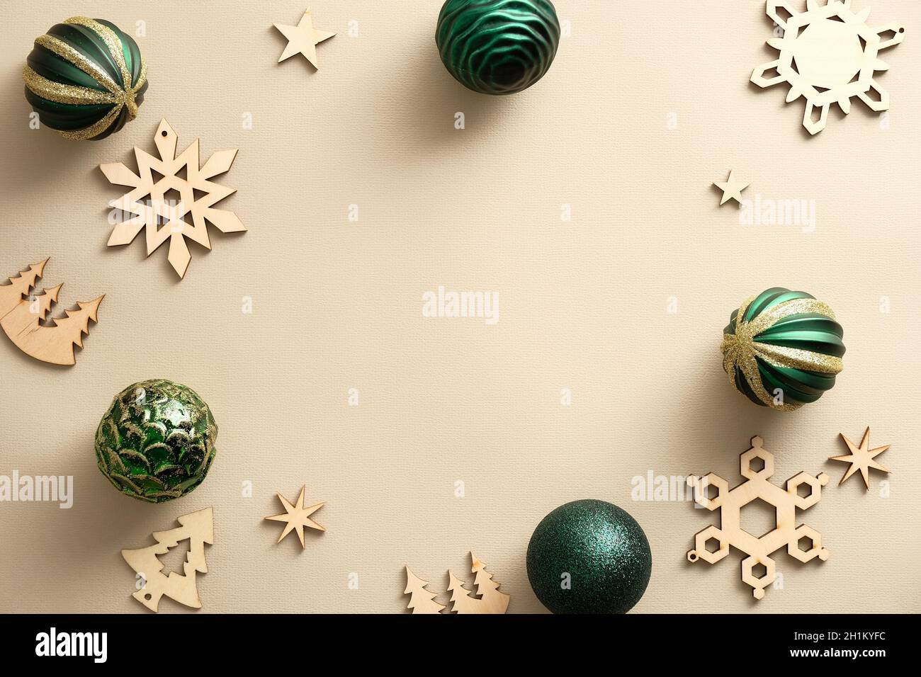 Vintage beige Christmas background with wooden decorations and green ...