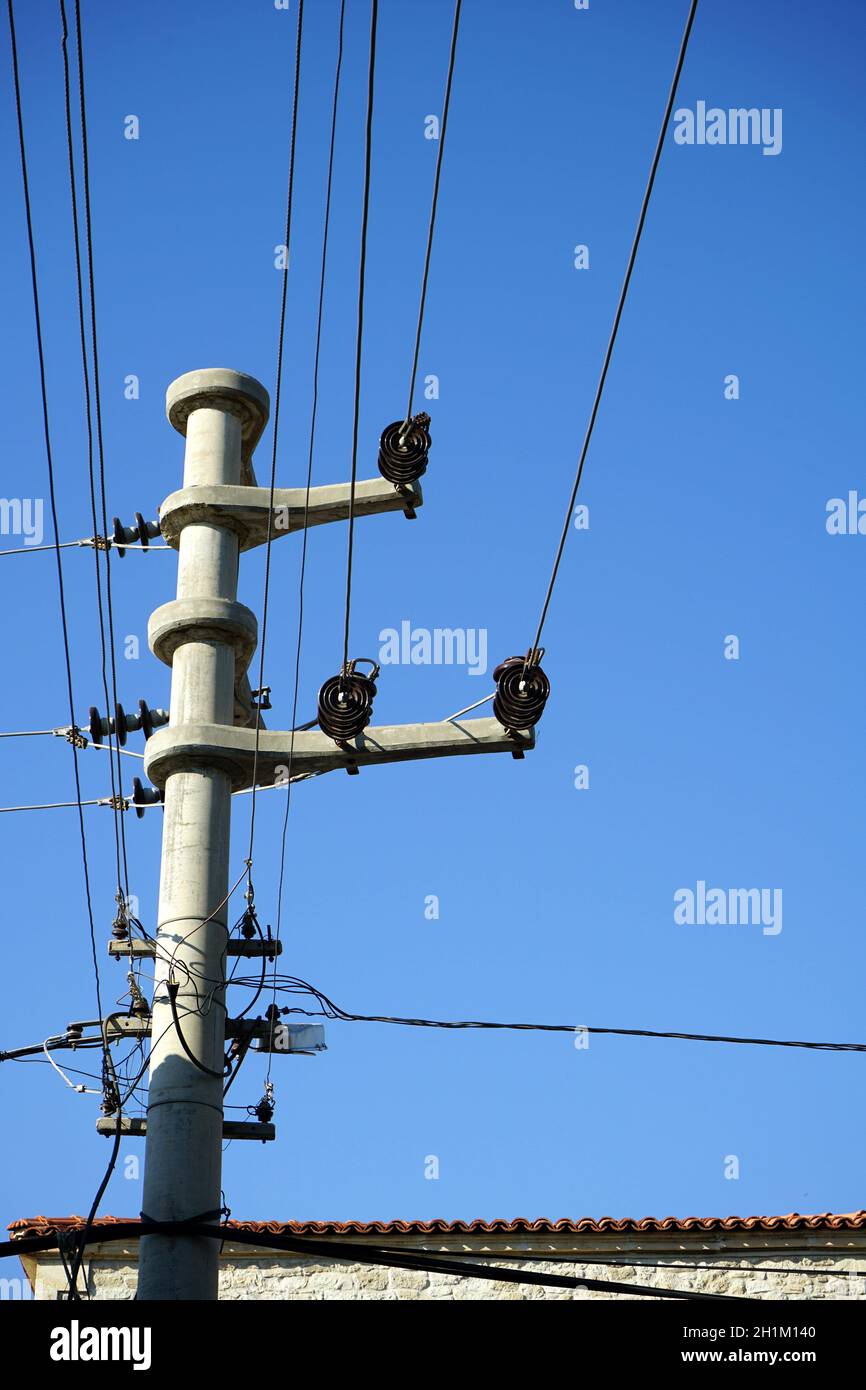 Close up of an electricity pole with wires with a blue sky Stock Photo ...