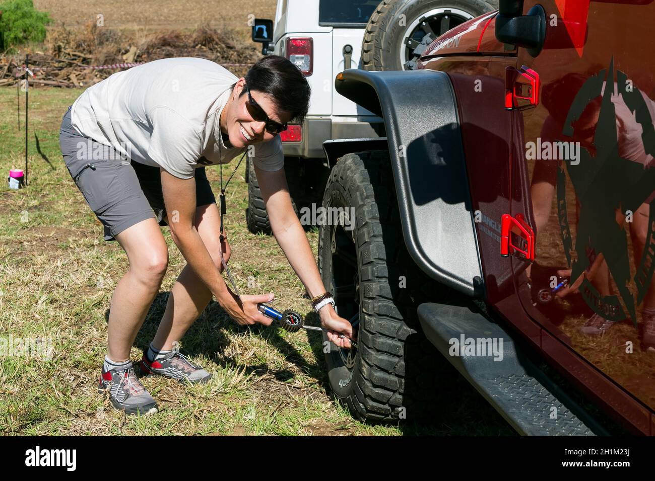 HARRISMITH, SOUTH AFRICA - Aug 11, 2021: A young man fixing his Jeep in ...