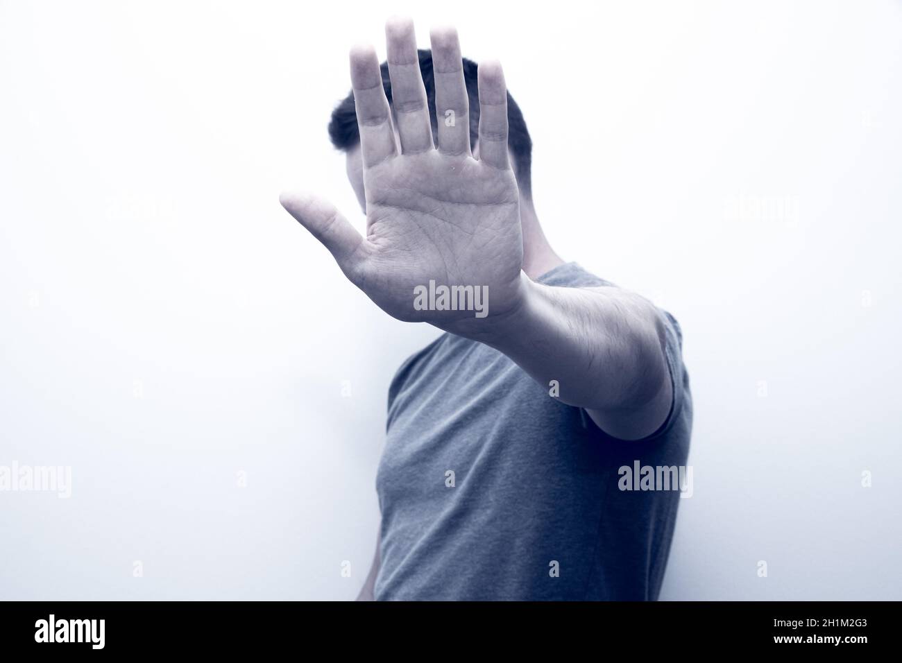 Man with a raised hand showing a stop or deny gesture Stock Photo - Alamy