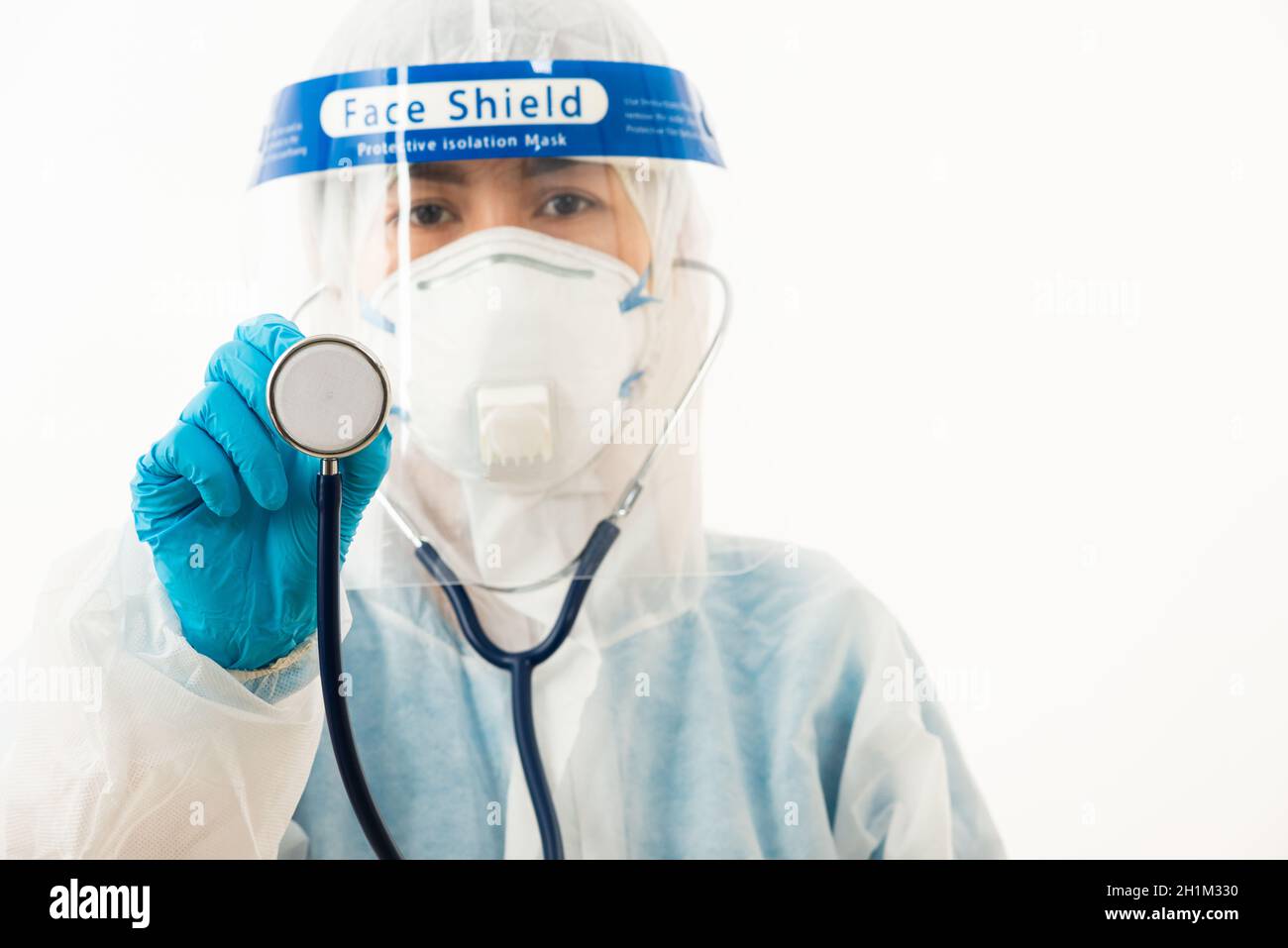 Closeup female medical scientist in PPE uniform wearing a face mask ...