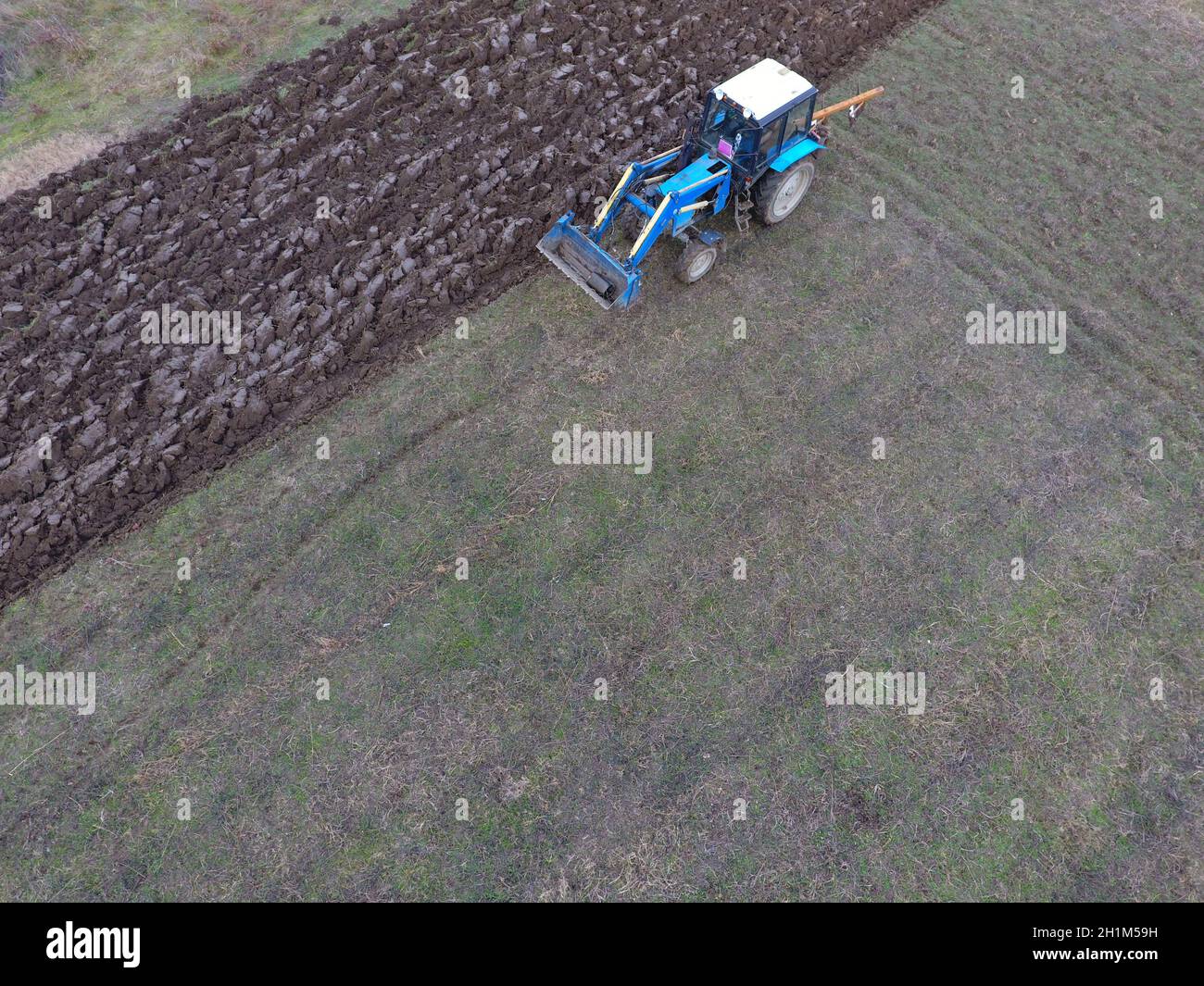 Tractor plowing the garden. Plowing the soil in the garden Stock Photo ...