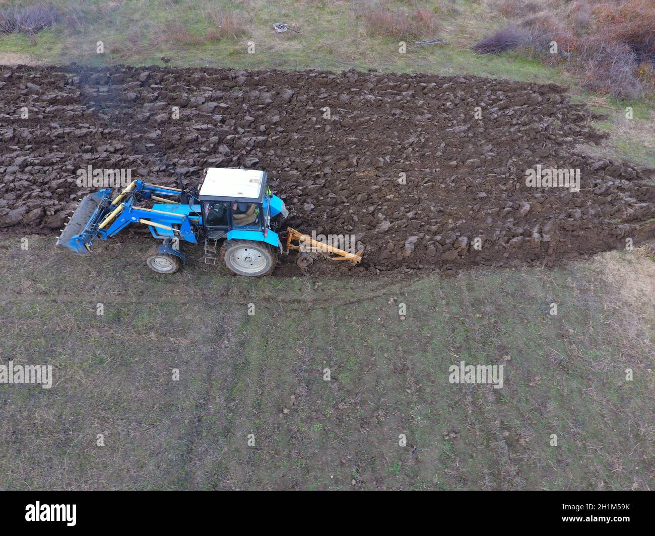 Tractor plowing the garden. Plowing the soil in the garden Stock Photo ...