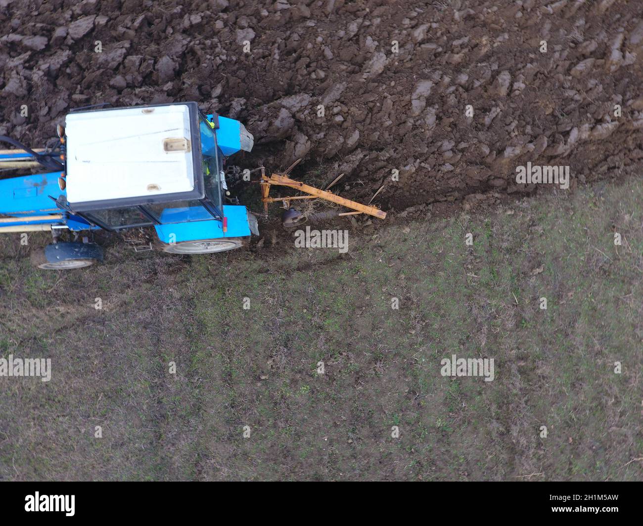 Tractor plowing the garden. Plowing the soil in the garden Stock Photo ...