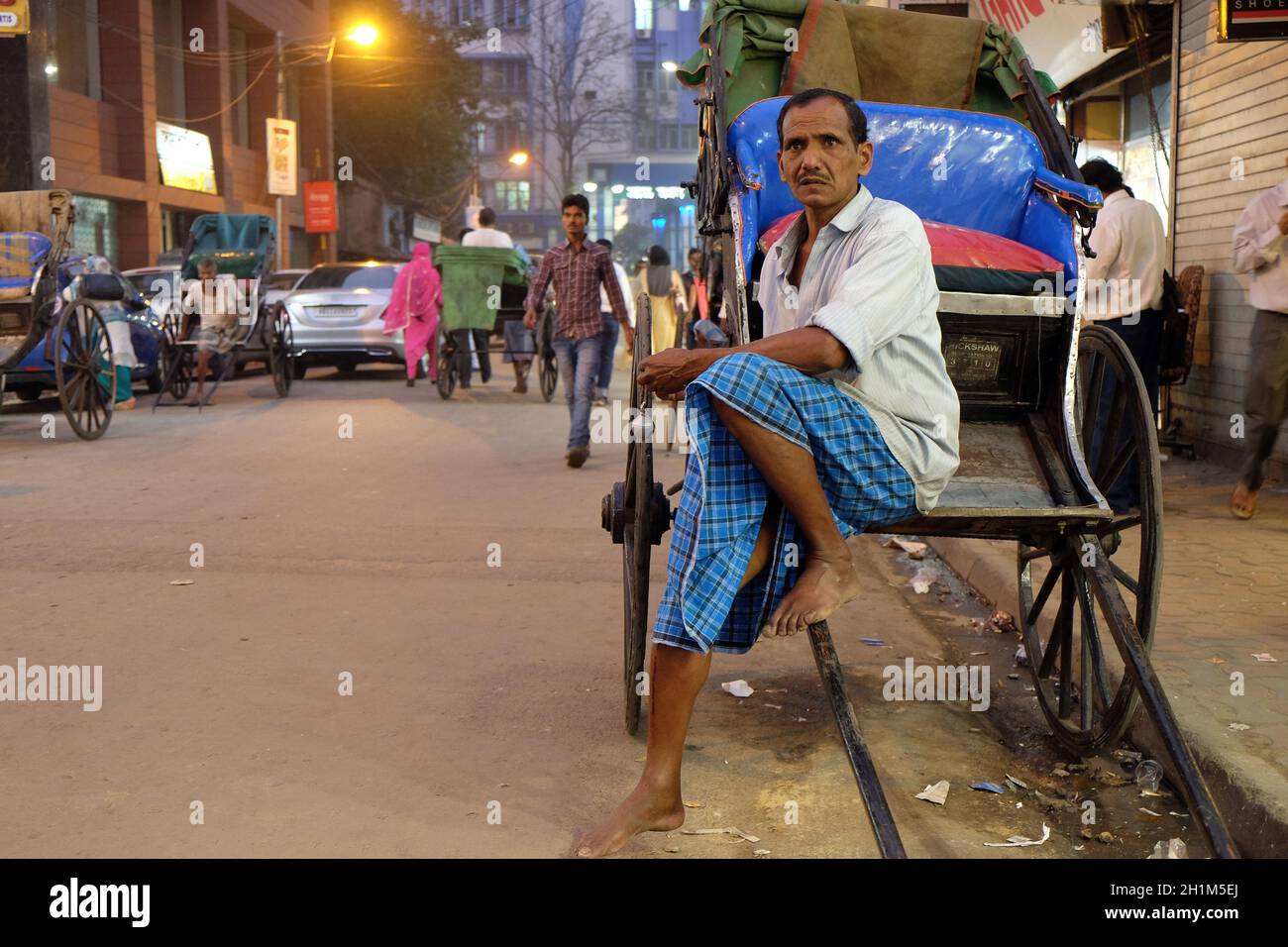A hand rickshaw puller waits for passengers in his rickshaw in Kolkata ...
