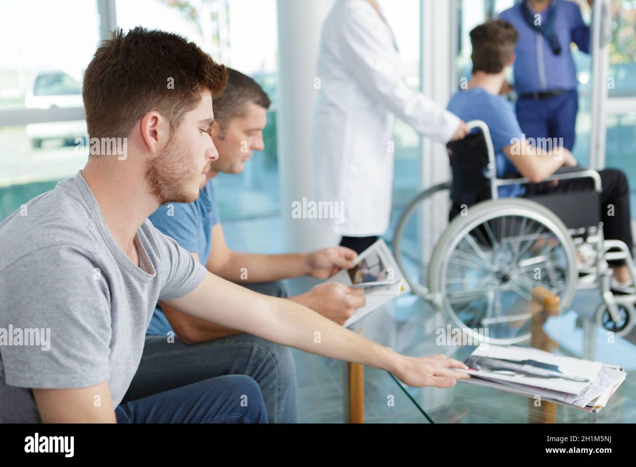men waiting in the lobby of a hospital Stock Photo - Alamy