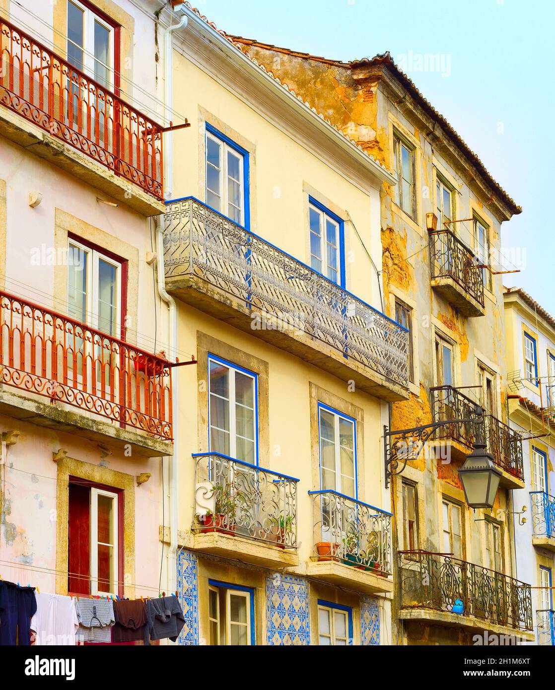 Typical portugese street with traditional tiled architecture and drying ...