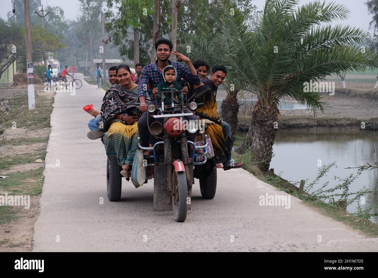 Indian tricycle motor rickshaw carrying passenger, Kumrokhali, West ...