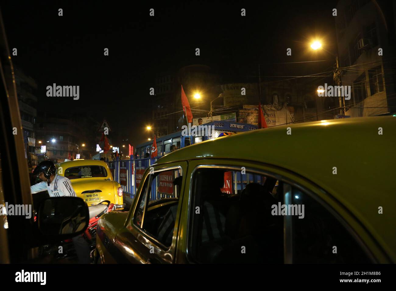 Dark city traffic blurred in motion at late evening on crowded streets ...