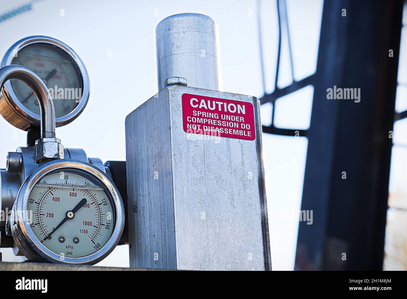 A Caution Spring Under Pressure Do Not Disassemble sign Stock Photo - Alamy