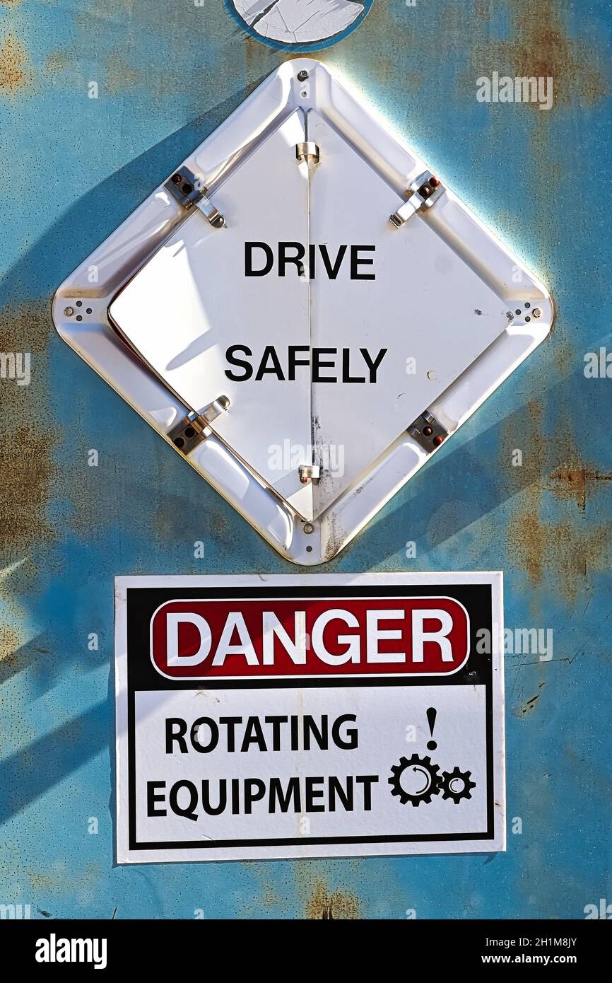 A Drive Safely and Danger Rotating Equipement sign Stock Photo - Alamy
