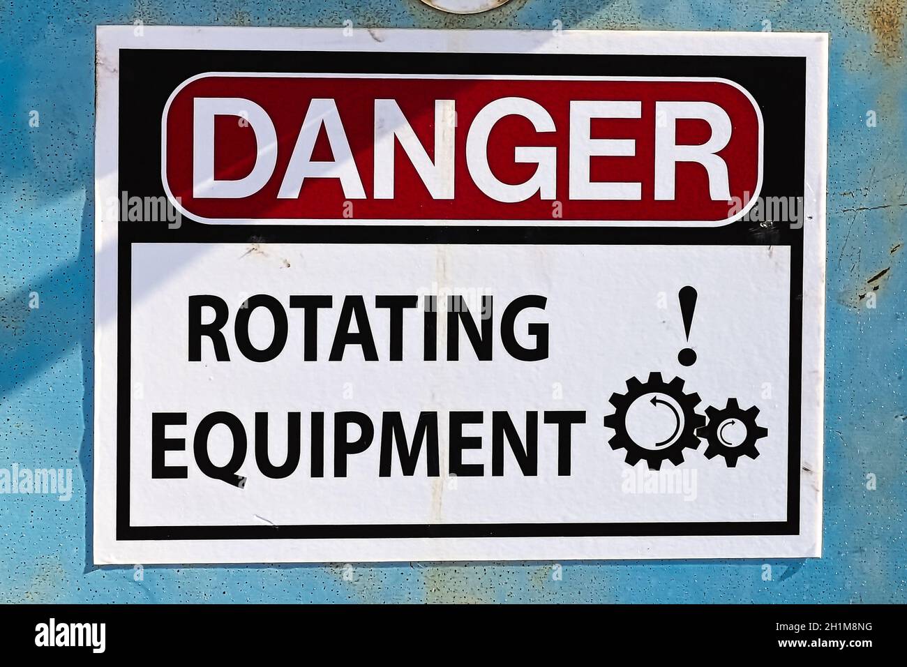 Closeup of a Danger Rotating Equipment sign Stock Photo - Alamy