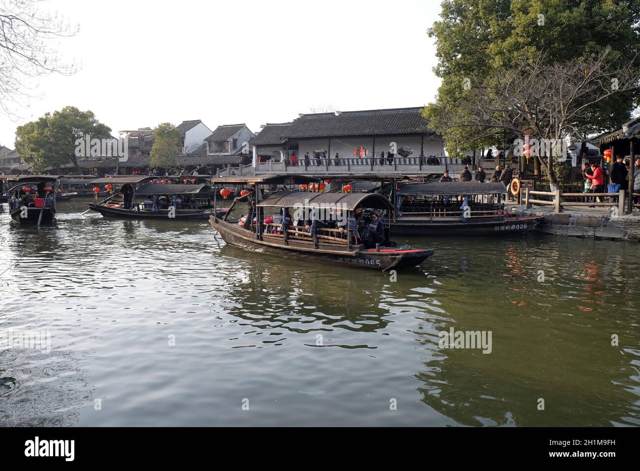 Tourist boats on the water canals of Xitang Town in Zhejiang Province ...